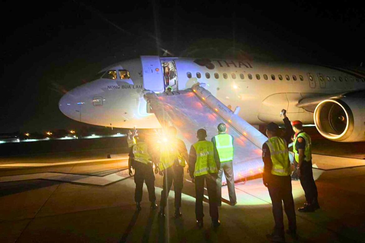 Thailand: a passenger opens the door of a plane during takeoff